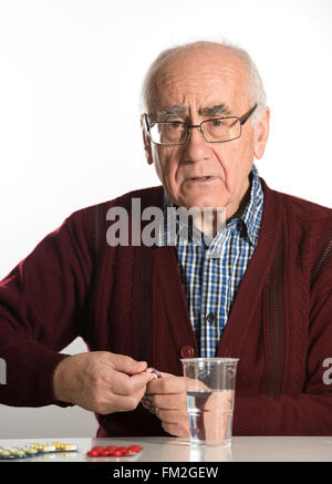displeased senior man in eyeglasses talking on smartphone and holding ...