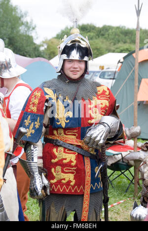 Knight reenactors dressed in chain mail and plate armor, dueling with ...