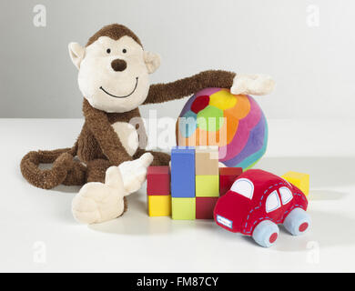 Toy monkey, car, ball, building blocks and teddy bear Stock Photo - Alamy