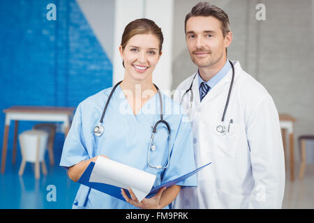 Happy doctors holding clipboard Stock Photo - Alamy