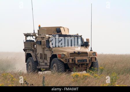 British Army Husky Protected Support Vehicle creates a dust cloud as it ...