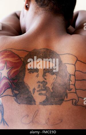 A man with a Che Guevara tattoo on his leg walks with a friend in the ...