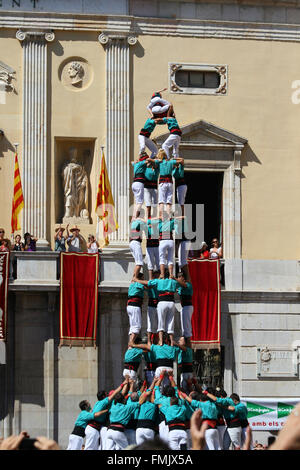 A traditional festival in Spain, with human tower teams in front of ...