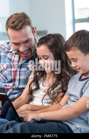 Siblings using digital tablet Stock Photo - Alamy