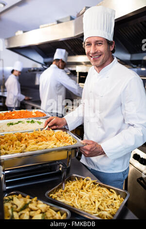 Male chef serving the order Stock Photo - Alamy
