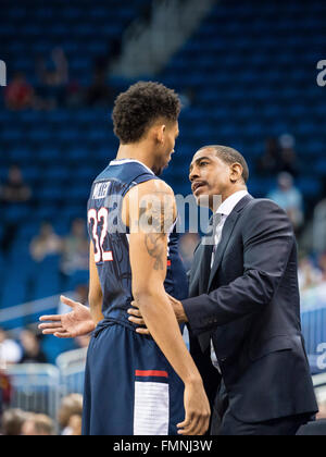 Connecticut forward Shonn Miller (32) pokes the ball away from Michigan ...