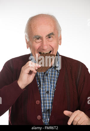 old senior man eating chocolate Stock Photo - Alamy