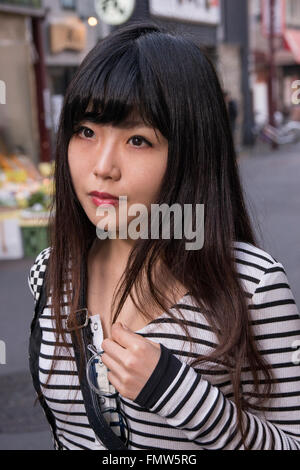 A young Japanese lady at Tokyo's premiere tourist attraction Sensoji ...