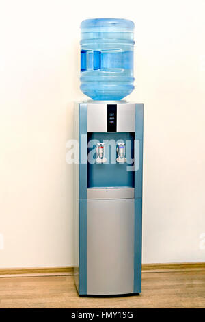 Electric water cooler on blue background Stock Photo - Alamy