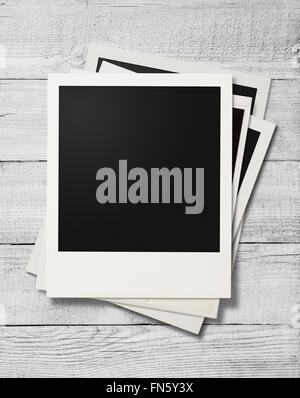 Photo frames on floor over white brick wall Stock Photo - Alamy