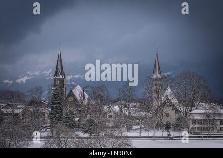 INTERLAKEN, SWITZERLAND. Winter snow in Hohe-Matte park, with the Grand ...