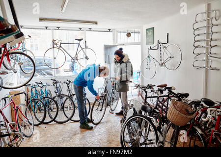two men in a cycle shop Stock Photo - Alamy