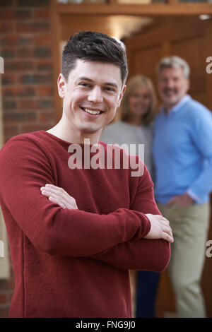 Portrait of smiling young mum, dad and their child together with their ...