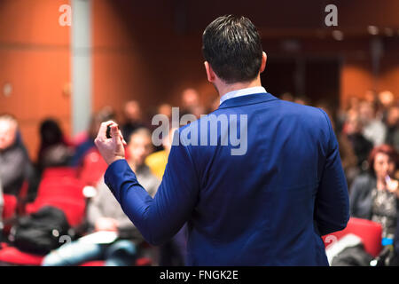 Male business speaker giving a talk at business conference event Stock ...