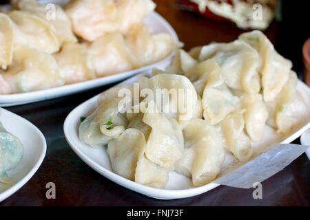 Making traditional dim sum Chinese dumplings in farmhouse kitchen ...