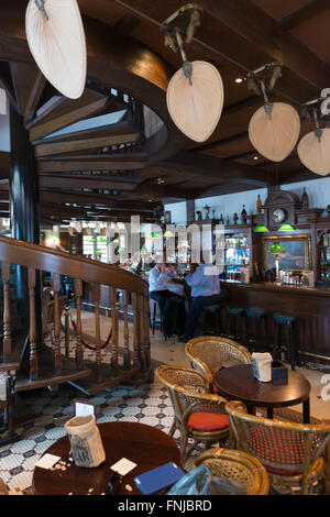 Raffles Long Bar; People drinking in the Long Bar, home of the ...