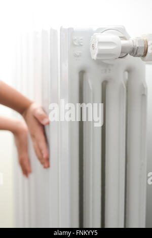 child hand touching Room radiator or heater Stock Photo - Alamy