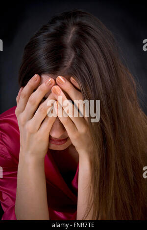 Emotional young European woman holding and enjoying wrapped gift next ...