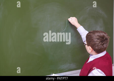Boy writes on the blackboard with chalk Stock Photo - Alamy