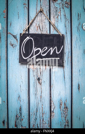A blue sign with an open word Stock Photo - Alamy