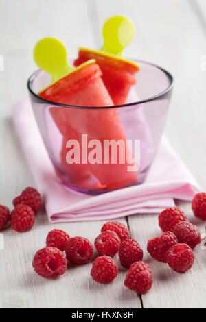 Raspberries in glass with ice on the table in the nature Stock Photo ...