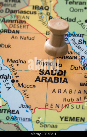 close up of the words Saudi Arabia on a world map marked with a push ...