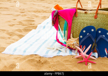 sunbathing accessories on sandy beach Stock Photo - Alamy