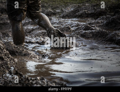 PEOPLE WALK IN THE MUD IN A FLOODED GLASTONBURY FESTIVAL, SOMERSET ...