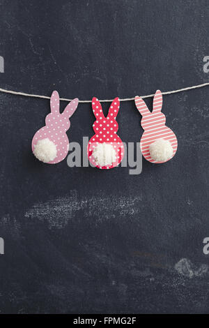 Pom pom colorful party garland on blue backgrouns Stock Photo - Alamy