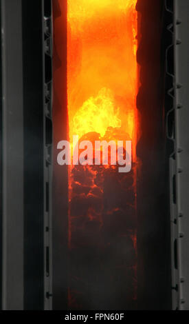 Pushing red hot coke from oven Stock Photo - Alamy