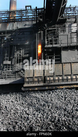 Pushing red hot coke from oven Stock Photo - Alamy