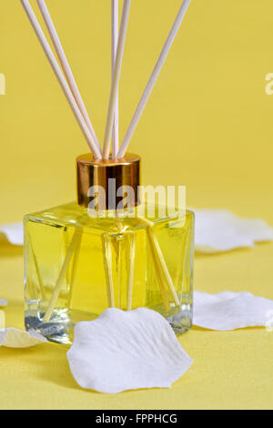 Rose reed diffuser on color background Stock Photo - Alamy
