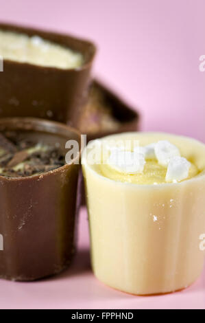 Assorted chocolates on pink background Stock Photo - Alamy