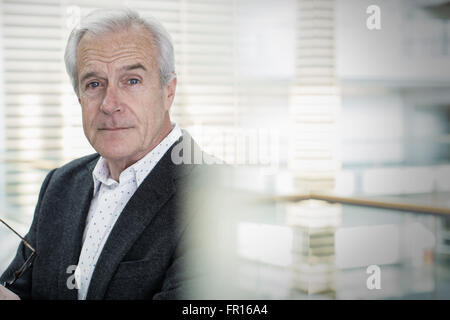 Serious Senior Man. Close up low key studio portrait of gray hair old ...