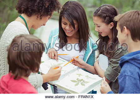 students and teacher identifying plants Stock Photo - Alamy