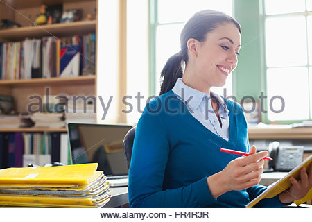 Teacher marking paperwork Stock Photo - Alamy