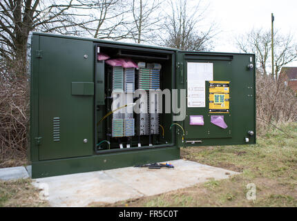 A roadside BT fiber optic and telephone cabinet with one door open ...