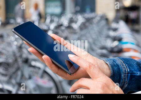 A woman using a Application on her phone while having coffee in a ...