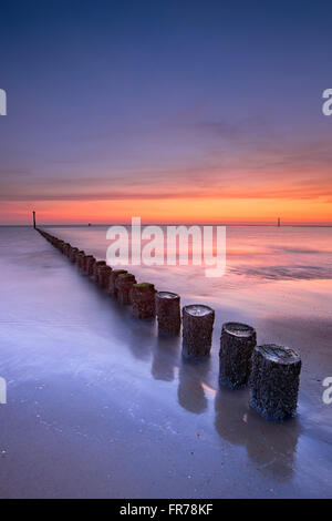 Sunset on the beach with breakwater, long time exposure Stock Photo - Alamy