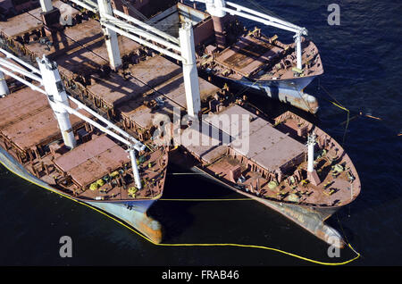 Aerial view of shipyard with ships in docks, cranes and warehouses ...