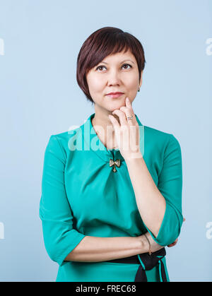 Business woman, thinking and portrait with smile in studio with ...