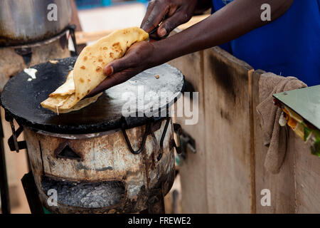 Chapatis being cooked on a stove, Uganda Africa Stock Photo - Alamy