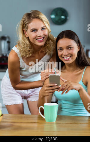 beautiful young women using mobile phone by the window of her luxury ...
