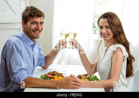 Portrait of cheerful couple toasting wineglasses Stock Photo - Alamy