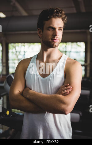 Athletic man standing by treadmill in gym Stock Photo - Alamy