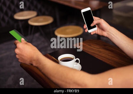 Hipster man giving his credit card Stock Photo - Alamy