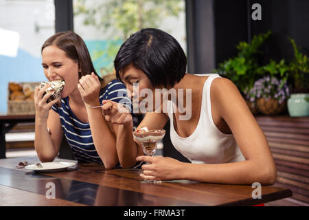 Friends is eating ice creams while they sitting outdoors Stock Photo ...