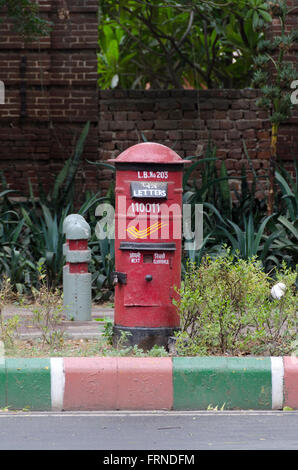 Red color indian post office speed letter post box with nature flowers ...