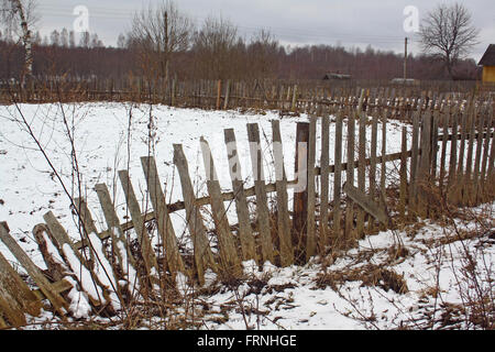 A wooden plank fence with old fallen spikes and deteriorated wood Stock ...