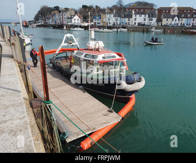 Oil pollution containment boom deployment exercise at Weymouth Harbour ...